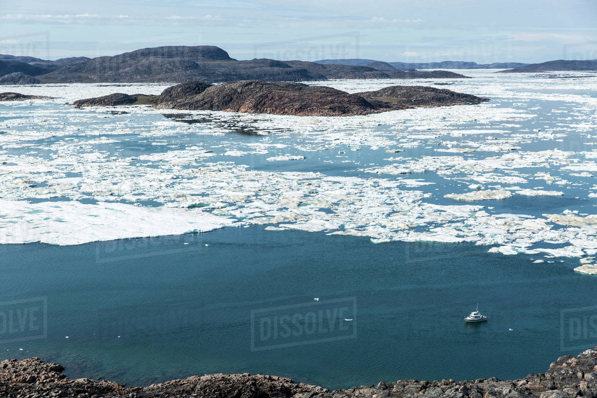 Canada, Nunavut Territory, C-Dory expedition boat surrounded by melting sea ice in Hudson Bay ...