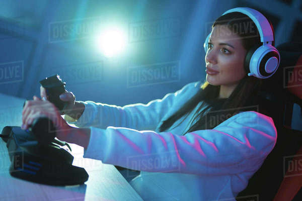 The beautiful gamer girl playing video games at the dark room - Stock ...