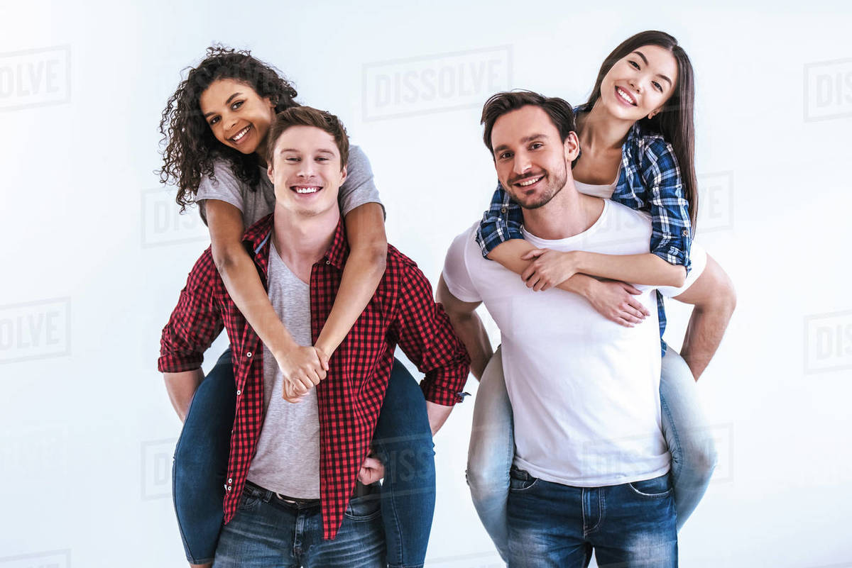 The two couples playing on the white background - Stock Photo - Dissolve