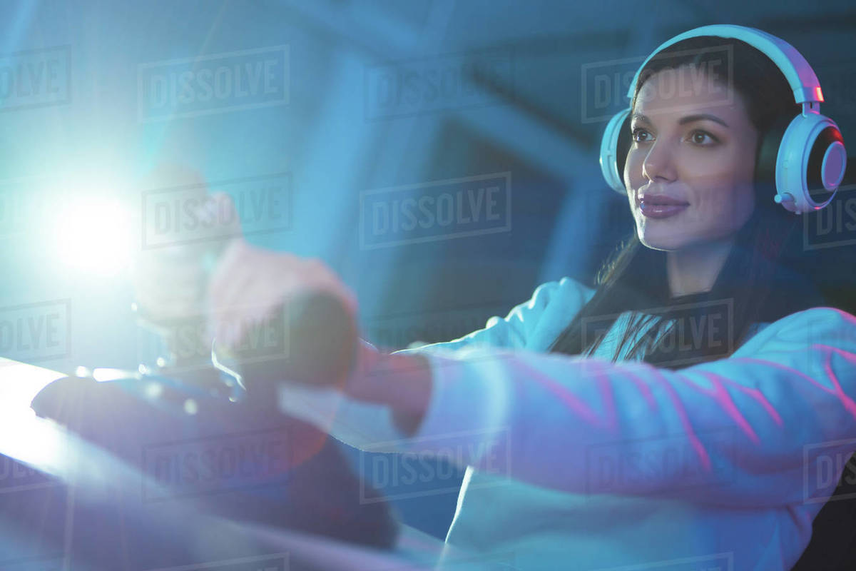 The beautiful gamer girl playing video games at the dark room - Royalty ...