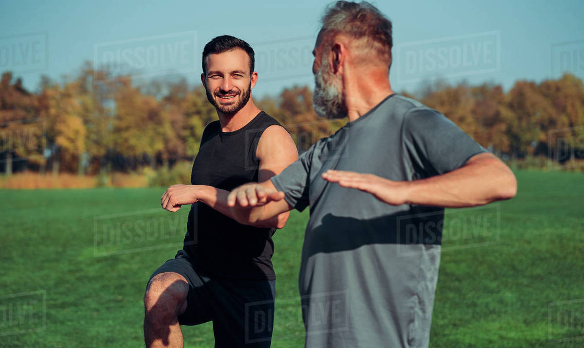 The two sportsmen doing exercise outdoor - Stock Photo - Dissolve