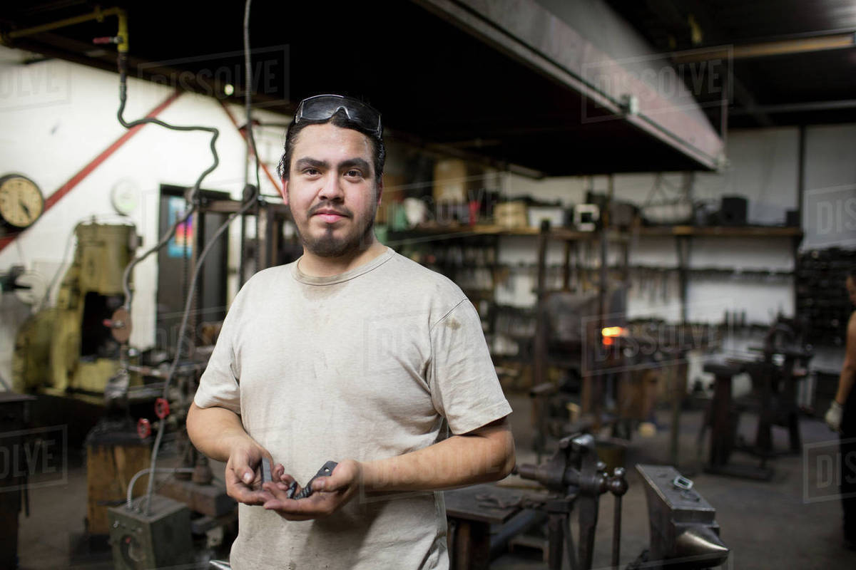 Portrait of male metalsmith in workshop - Stock Photo - Dissolve