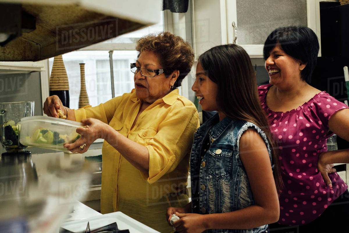 Grandmother teaching granddaughter to cook - Royalty-free Stock Photo ...