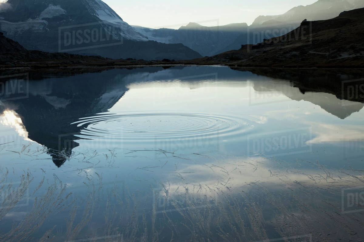 Ripple in still mountain lake - Royalty-free Stock Photo | Dissolve