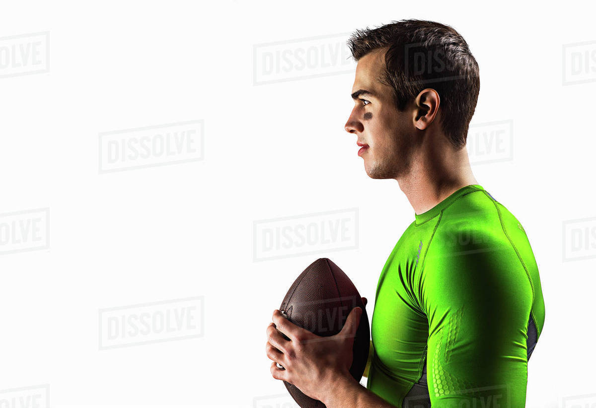 Athletic man holding football - Royalty-free Stock Photo | Dissolve