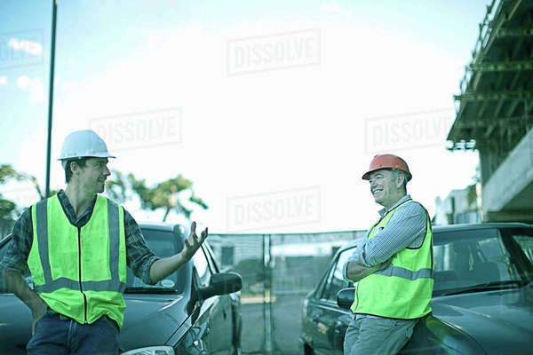 Construction workers talking on site - Stock Photo - Dissolve