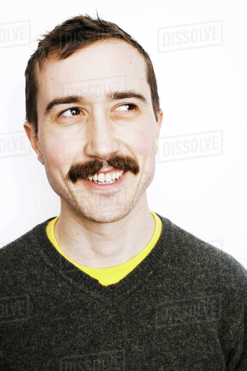 Young man with moustache, smiling - Royalty-free Stock Photo | Dissolve