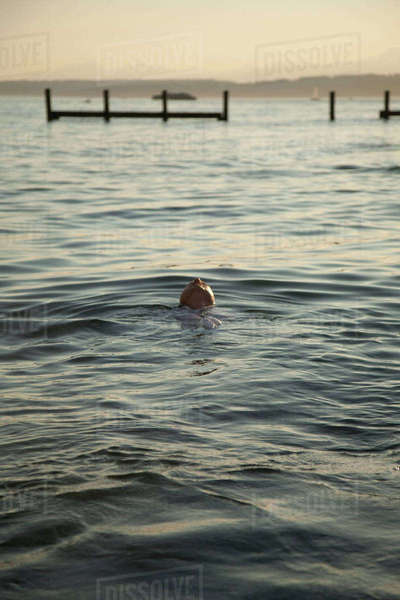 Man floating in water - Stock Photo - Dissolve