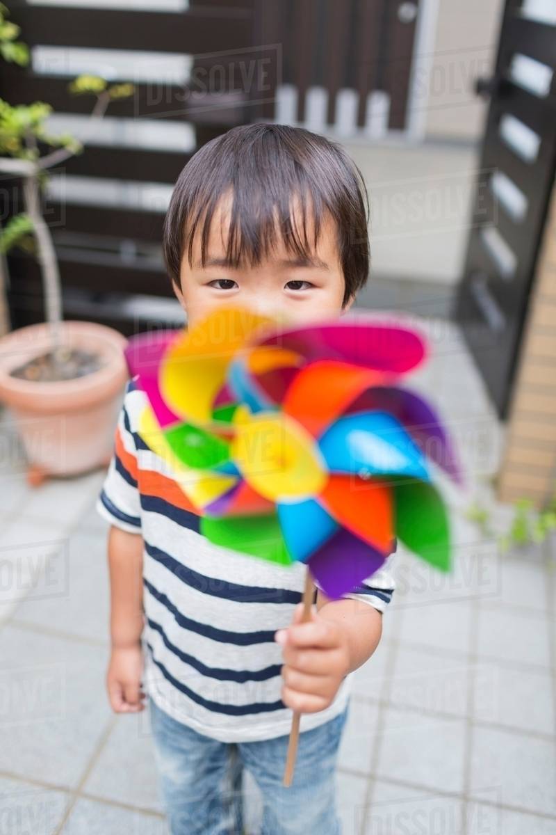 Little boy with a pinwheel - Stock Photo - Dissolve