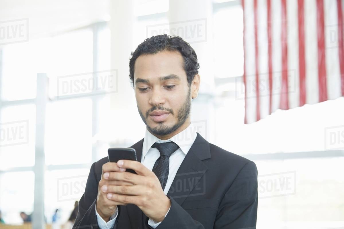Businessman using smartphone - Stock Photo - Dissolve