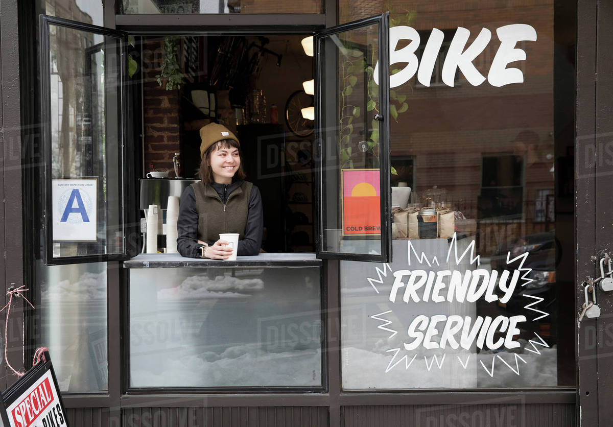 Female employee at service window, Nike and Coffee shop, New York, USA ...
