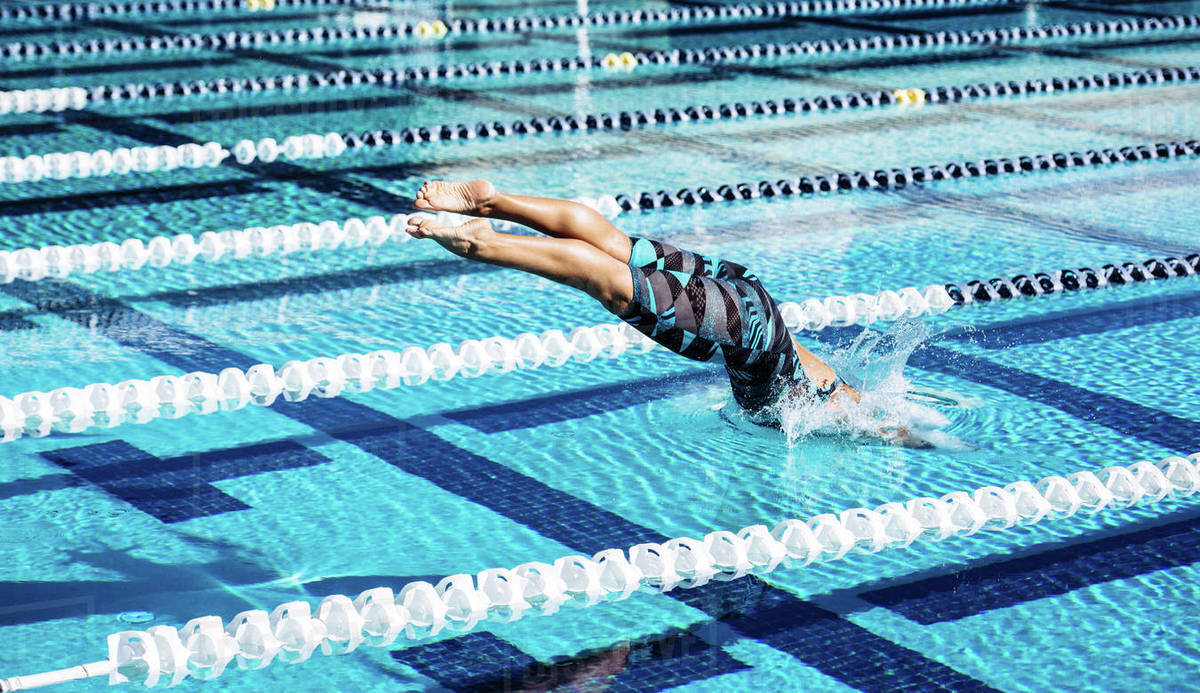 Swimmer diving into pool - Stock Photo - Dissolve