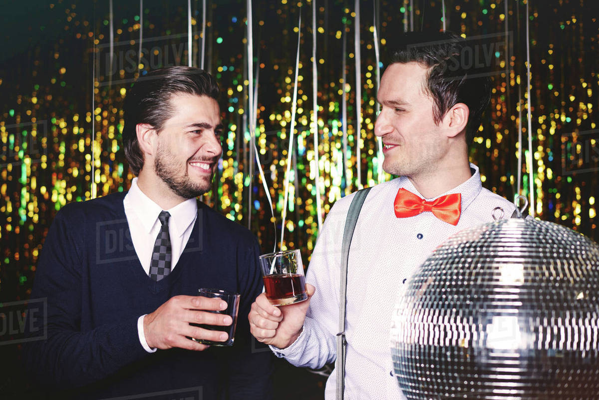 Two men at party, holding drinks - Royalty-free Stock Photo | Dissolve