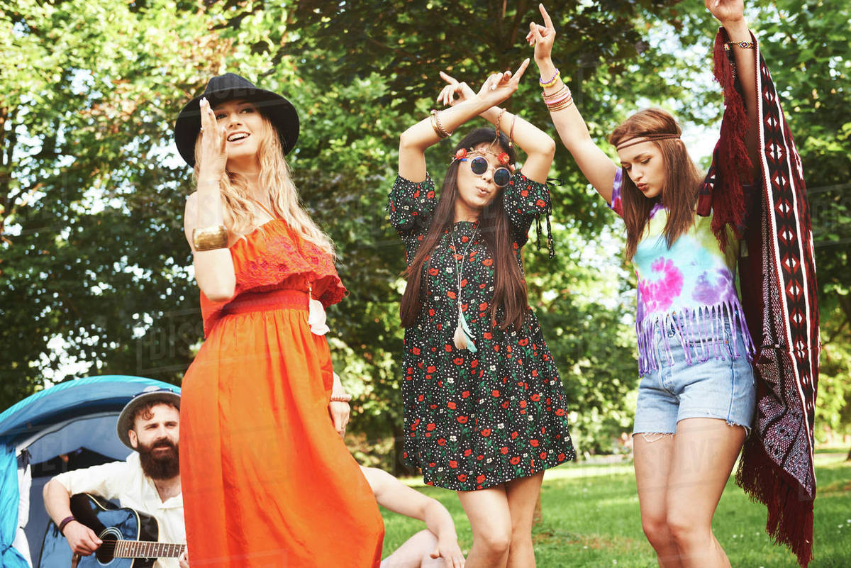 Three young boho women dancing together at festival - Stock Photo ...