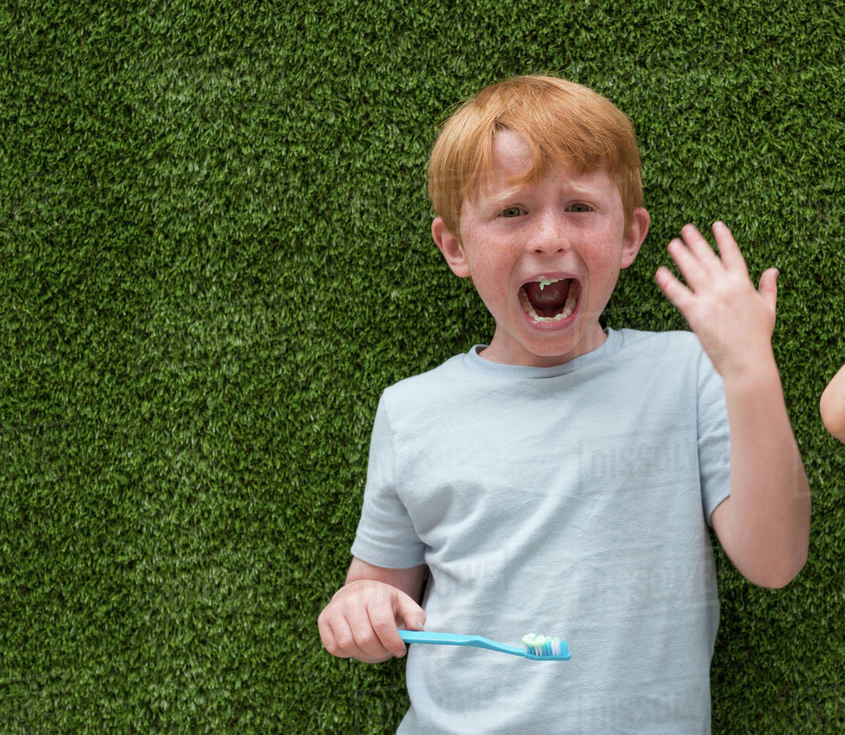 Upset boy brushing teeth - Royalty-free Stock Photo | Dissolve