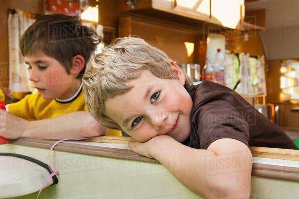 Two boys leaning out of caravan window, portrait - Royalty-free Stock ...