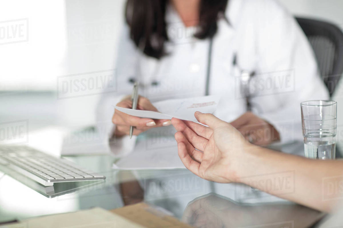 Cropped view of doctor handing patient prescription - Royalty-free ...