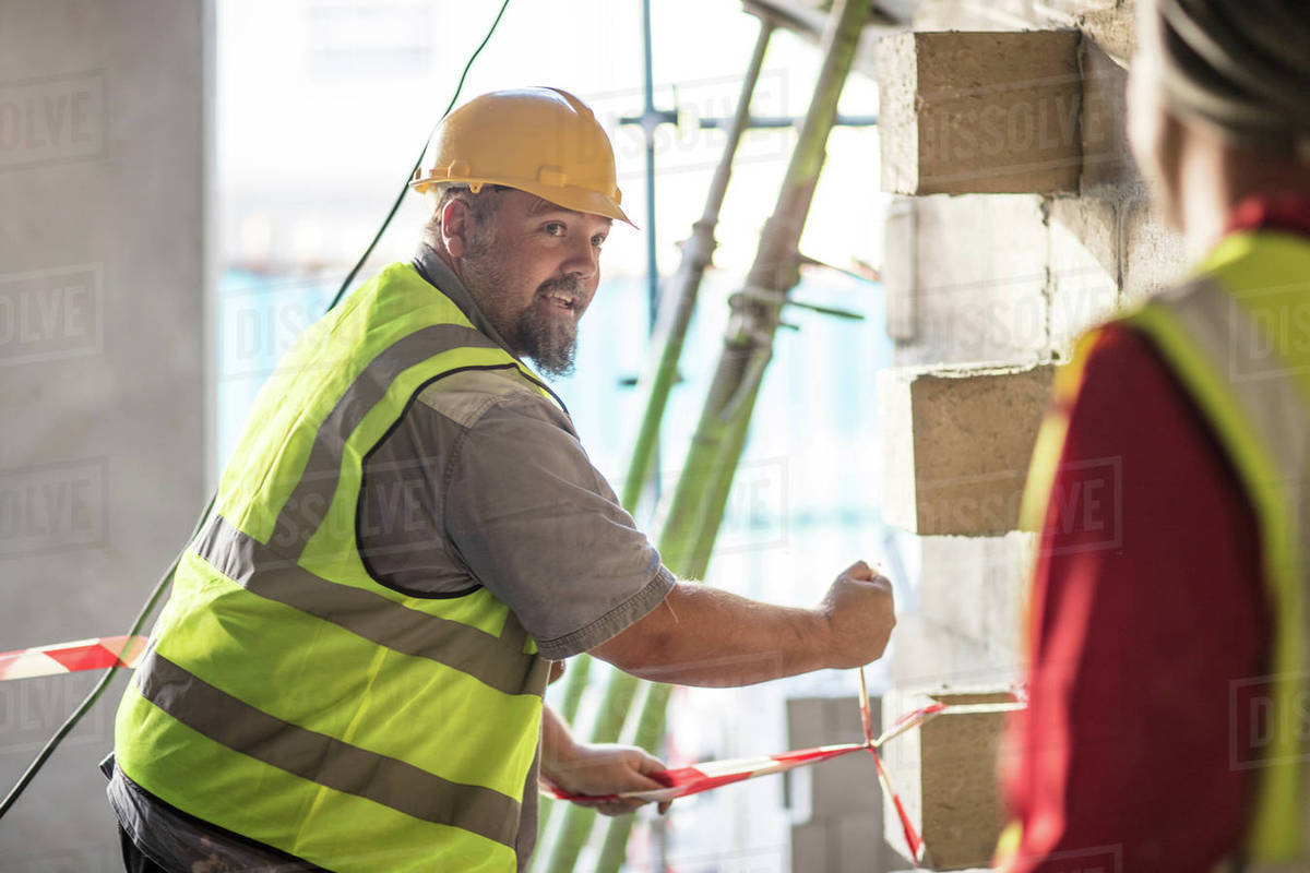Construction workers on building site - Royalty-free Stock Photo | Dissolve