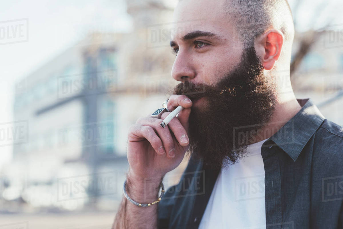 Bearded man smoking - Royalty-free Stock Photo | Dissolve