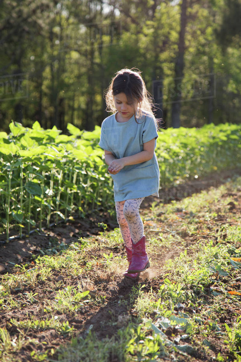 Young girl walking on farm, holding hands together - Royalty-free Stock ...