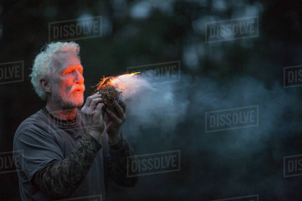 Man starting fire light - Royalty-free Stock Photo | Dissolve