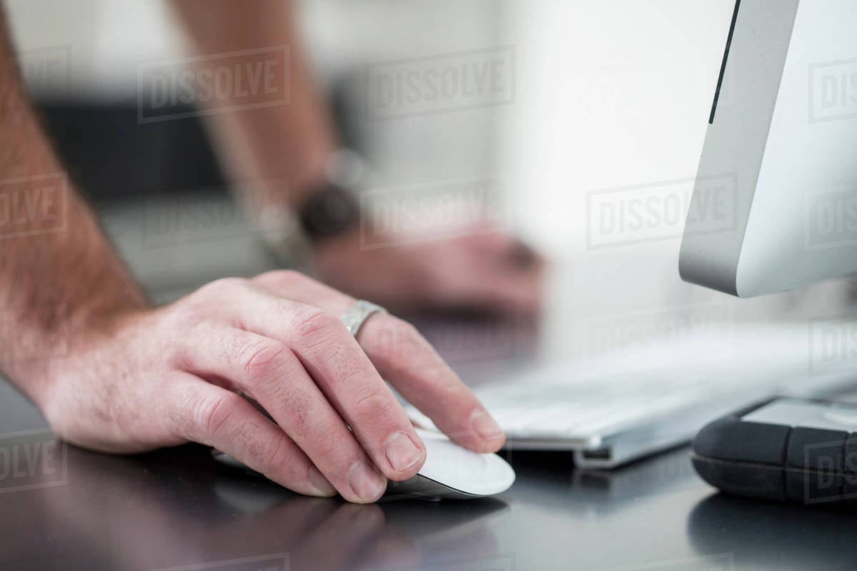 Cropped view of man using computer mouse - Royalty-free Stock Photo ...