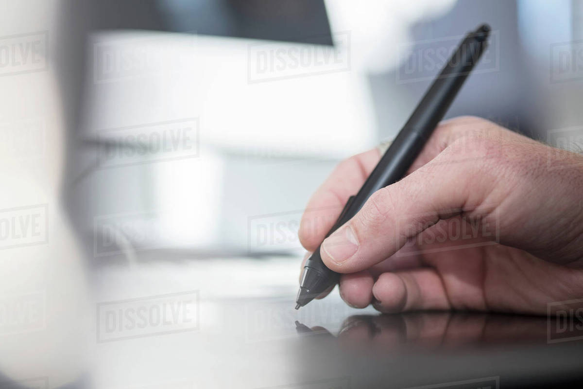 Cropped view of man writing with digital pen - Royalty-free Stock Photo ...