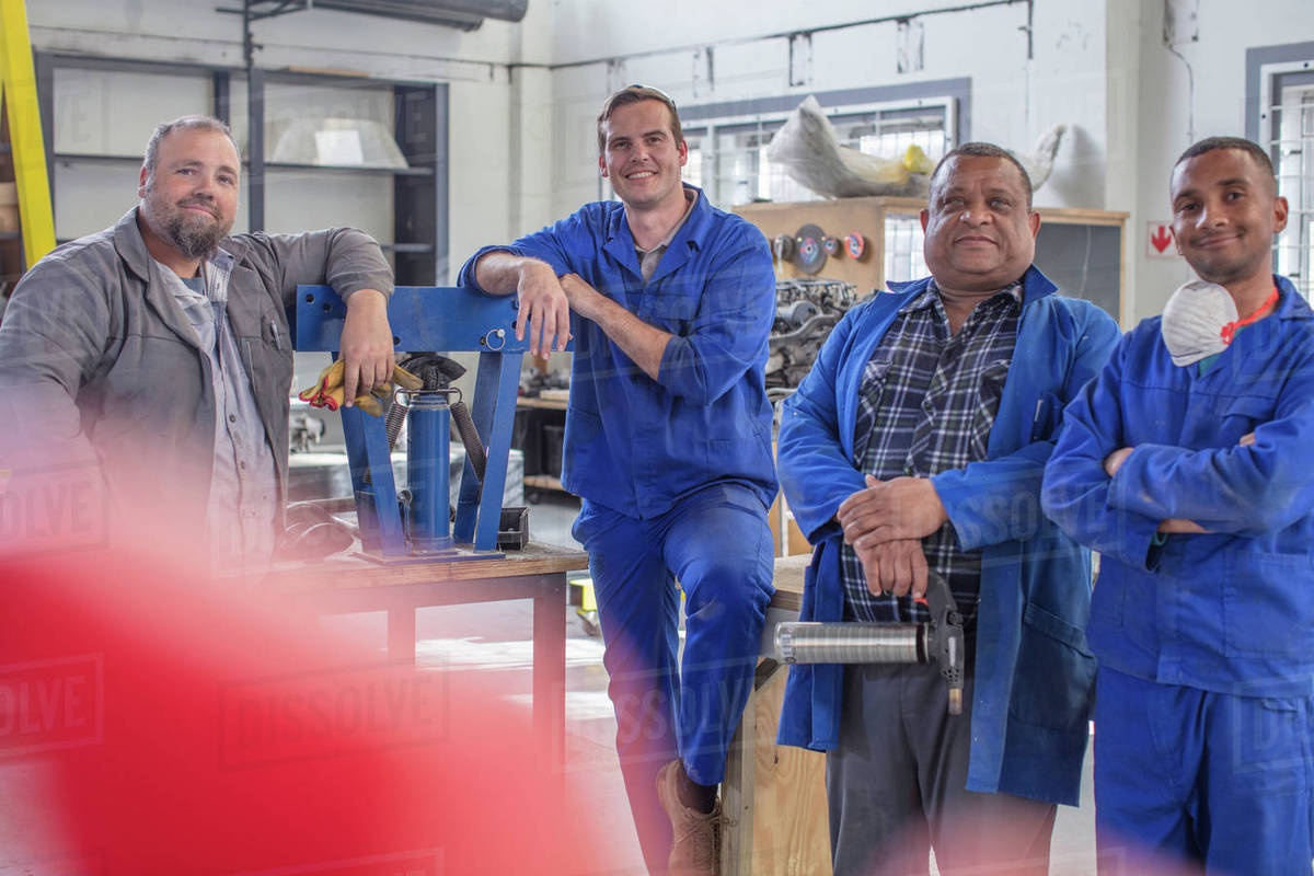 Portrait of male car mechanic team in repair garage - Royalty-free ...