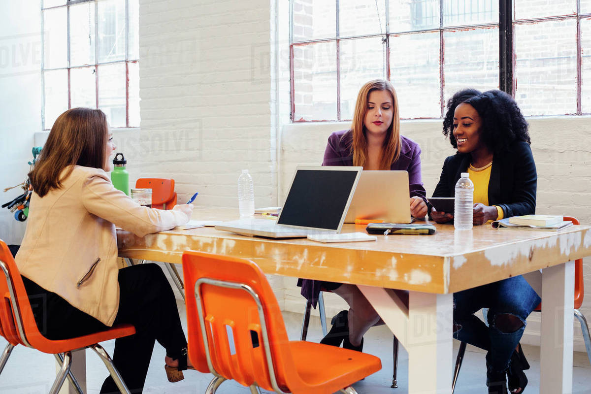 Colleagues in industrial office building working at desk - Royalty-free ...