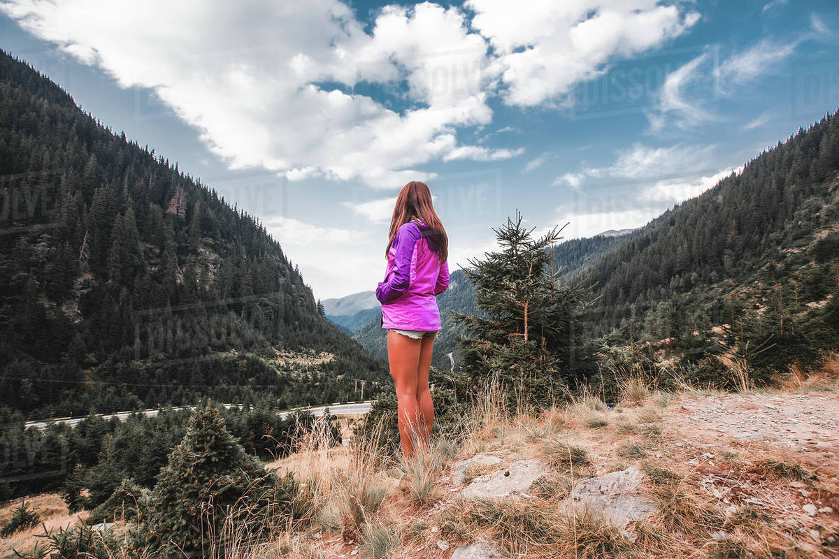 Young woman looking out over valley forest landscape, Draja, Vaslui ...