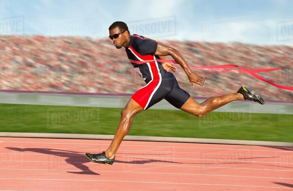 Runner crossing the finish line - Stock Photo - Dissolve