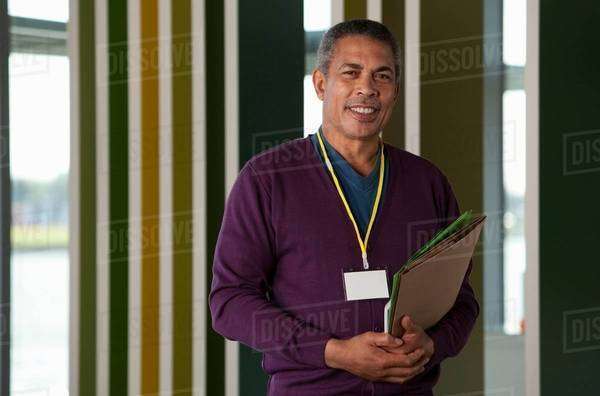 Man holding files, portrait - Royalty-free Stock Photo | Dissolve