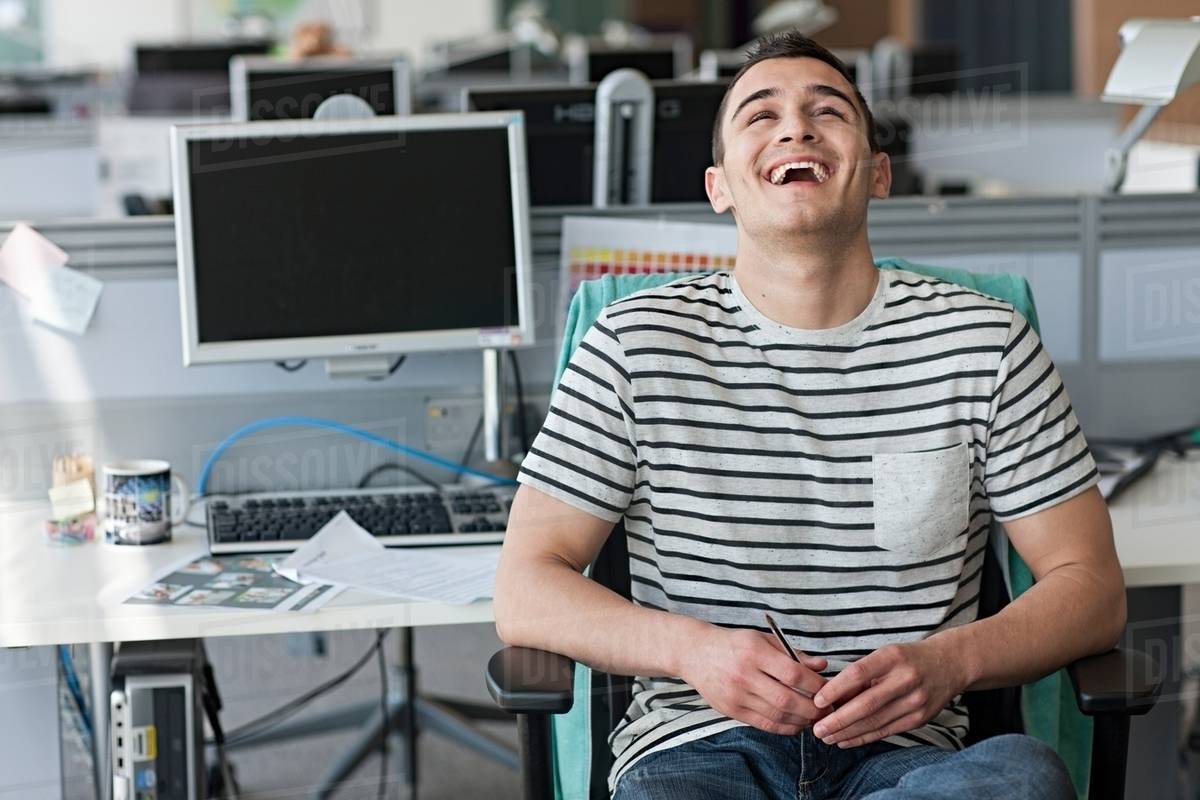 Man laughing in office - Royalty-free Stock Photo | Dissolve