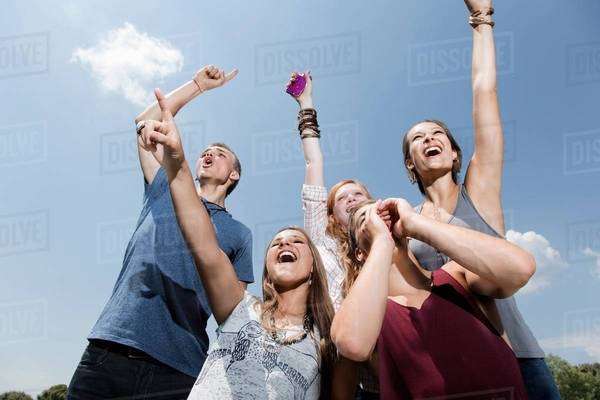 Five friends cheering, low angle - Royalty-free Stock Photo | Dissolve