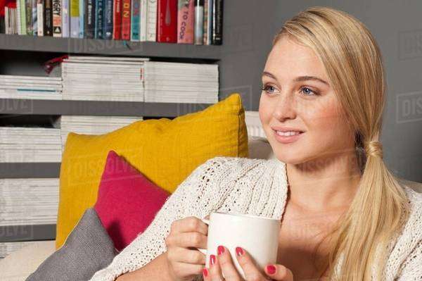 Portrait of woman holding cup - Royalty-free Stock Photo | Dissolve