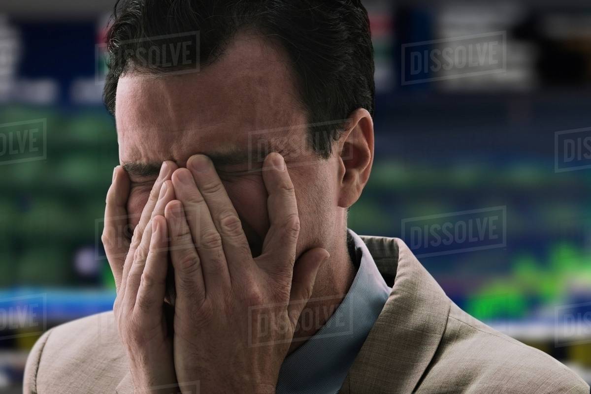 Businessman crying at stock exchange - Royalty-free Stock Photo | Dissolve