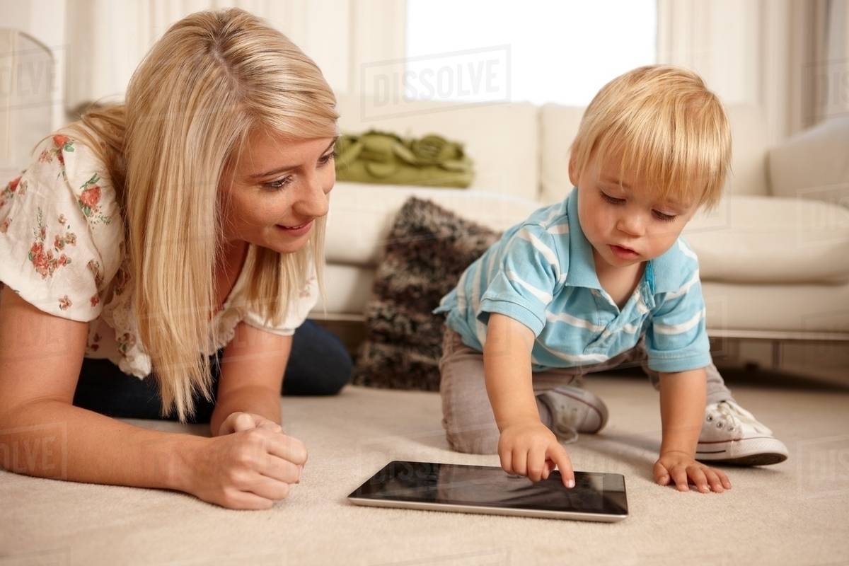 Mother and son using digital tablet - Royalty-free Stock Photo | Dissolve