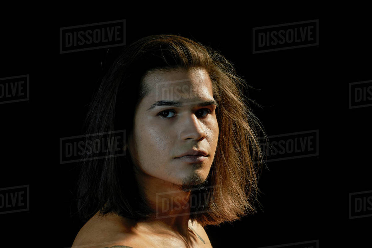 Portrait of young man, black background - Stock Photo - Dissolve