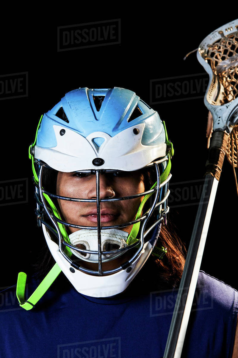 Portrait of lacrosse player, black background - Stock Photo - Dissolve