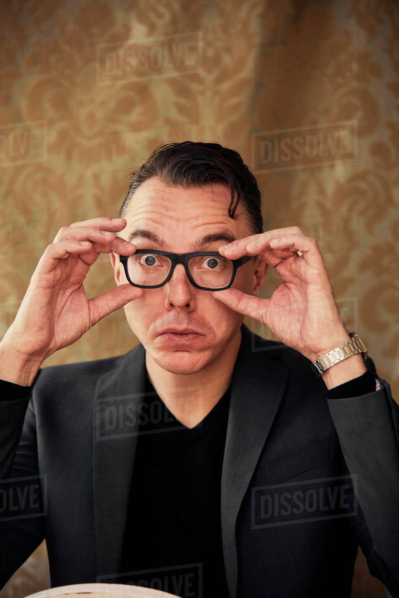 Comedian adjusting spectacles for clearer vision - Royalty-free Stock ...