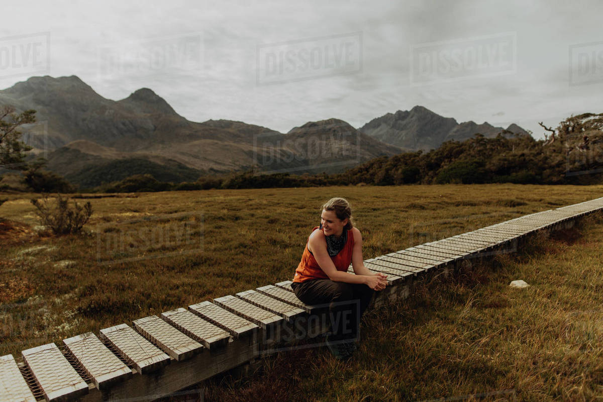 Woman relaxing on trail path, Queenstown, Canterbury, New Zealand ...
