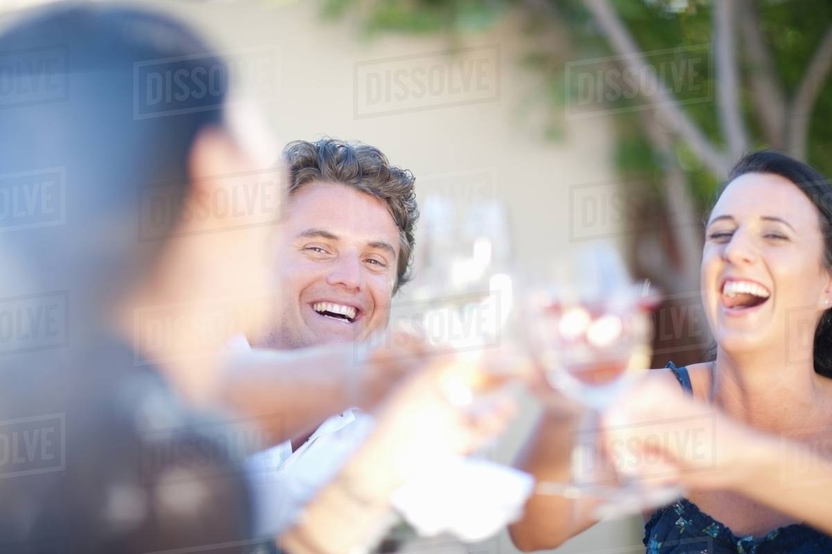 Friends toasting each other outdoors - Royalty-free Stock Photo | Dissolve
