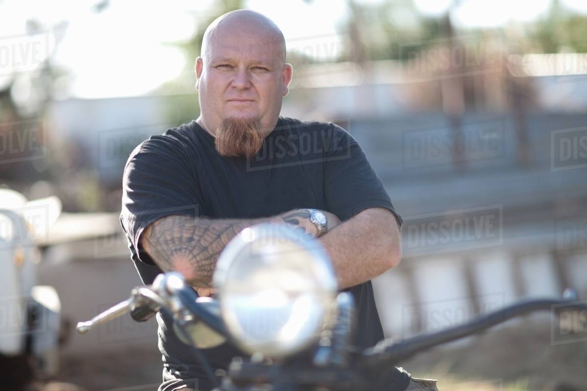 Man sitting on motorcycle - Royalty-free Stock Photo | Dissolve