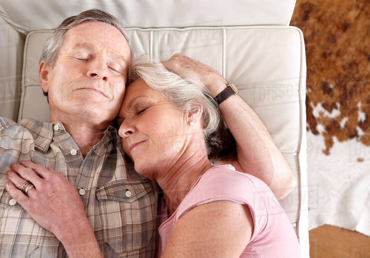 Older couple napping on sofa - Royalty-free Stock Photo | Dissolve