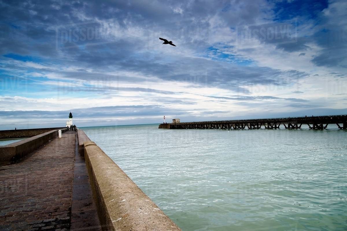 Harbor wall and wooden pier - Stock Photo - Dissolve