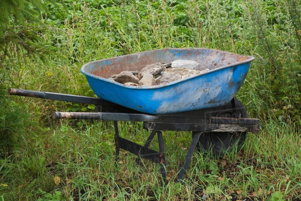 Wheelbarrow with rocks - Stock Photo - Dissolve