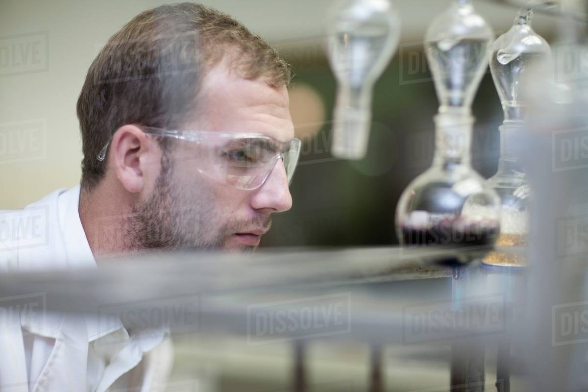 Oenologist monitoring sample testing in laboratory - Stock Photo - Dissolve