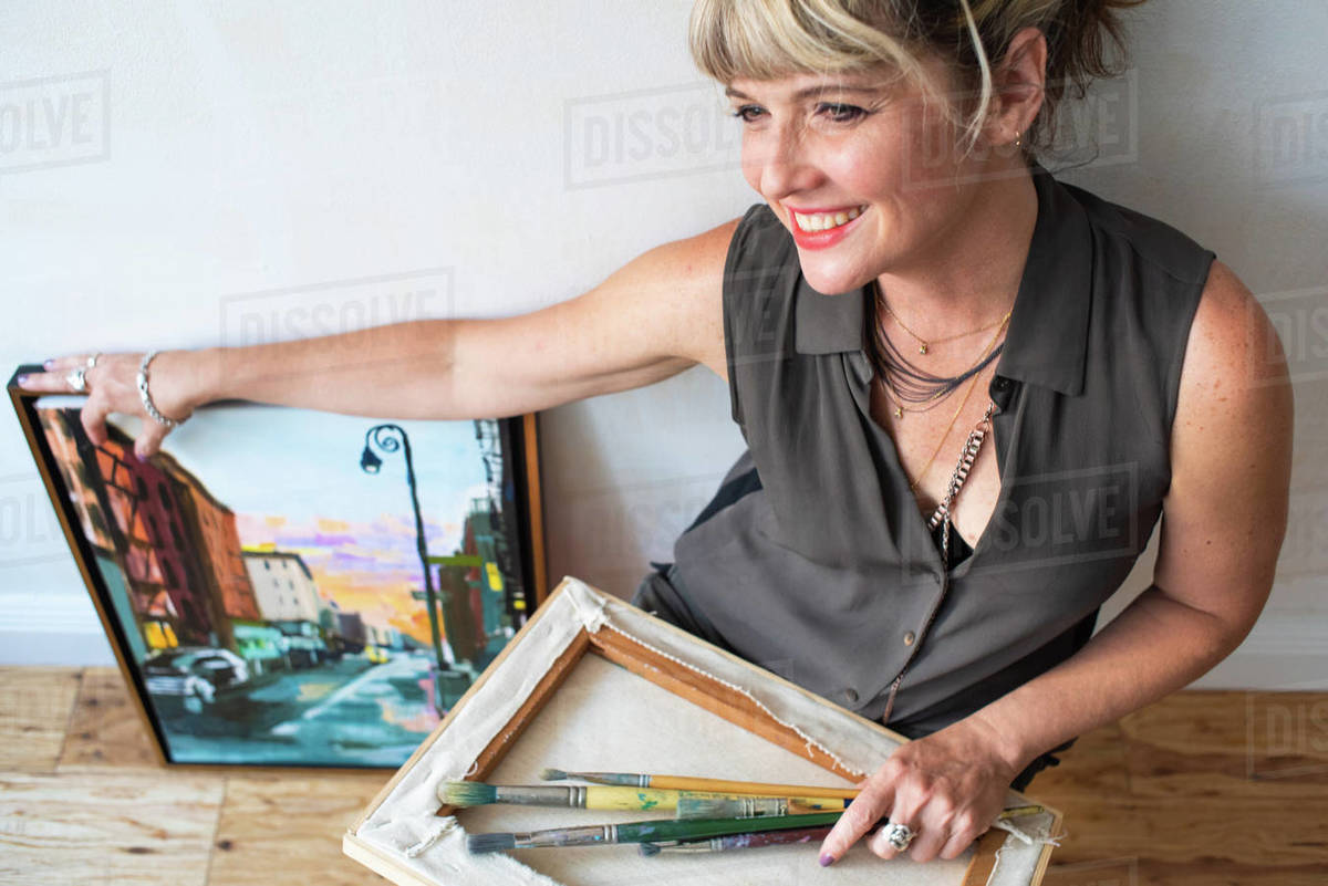 Portrait of fine art painter with painting and paint brushes - Royalty ...