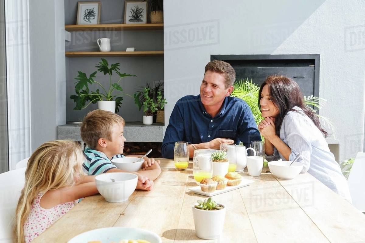 Parents talking with children during lunch at home - Royalty-free Stock ...
