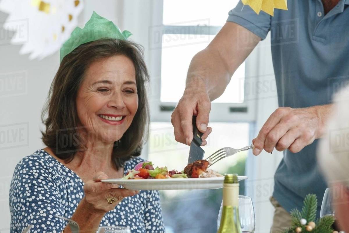 Man serving woman at dining table in home party - Royalty-free Stock ...